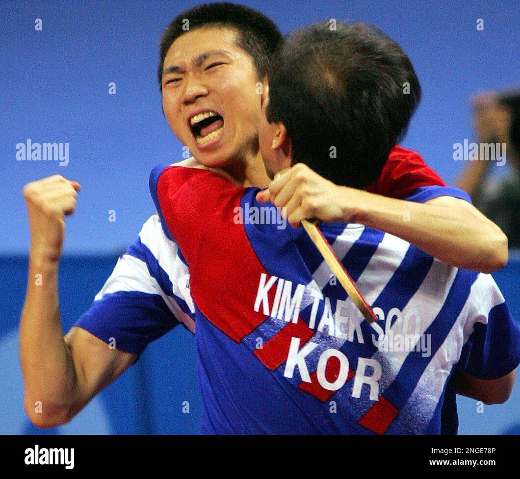 Korea's Ryu Seung Min, left, celebrates with his coach after defeating ...