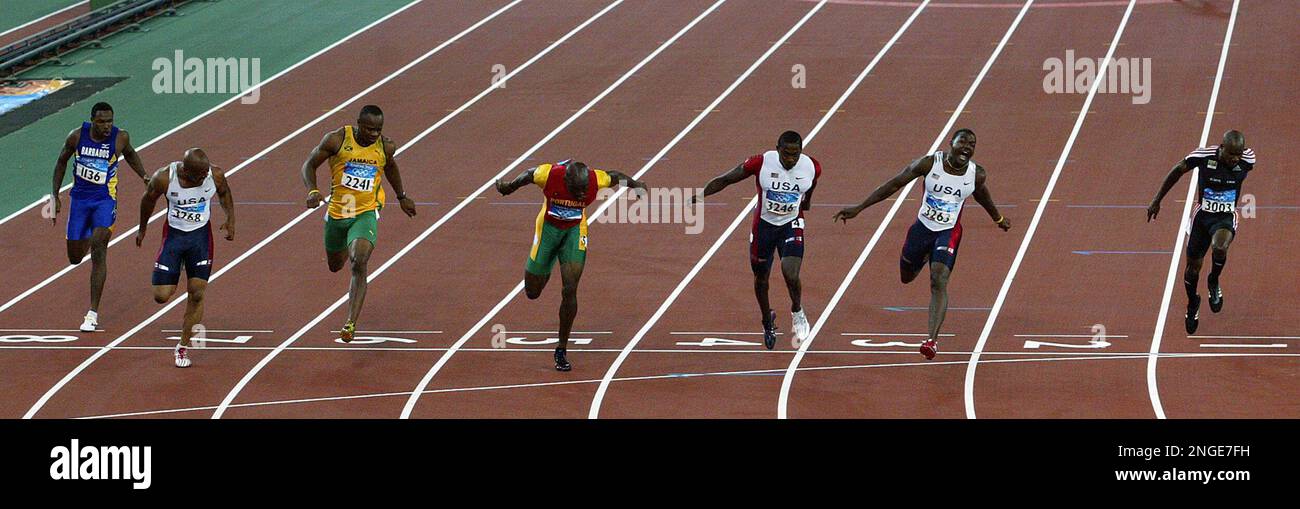 At the finish of the 100m are, left to right: Obadele Thompson, of ...