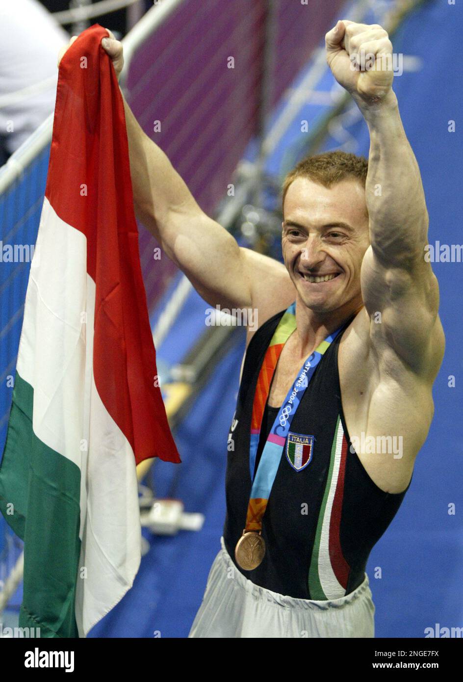 Italy's Yuri Chechi celebrates his bronze medal in the rings during the ...