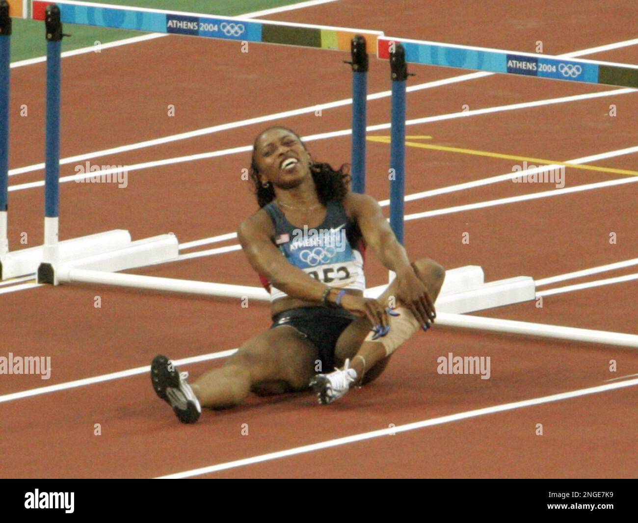 Gail Devers, of the United States, hold her leg after pulling up short ...