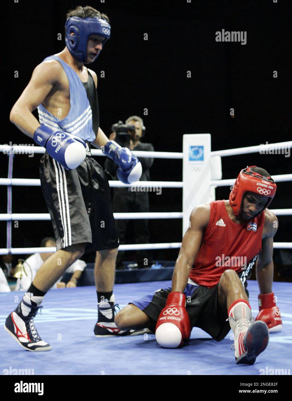 Uzbekistan's Dishod Mahmudov, left, looks at Cuba's Yudel Johnson ...