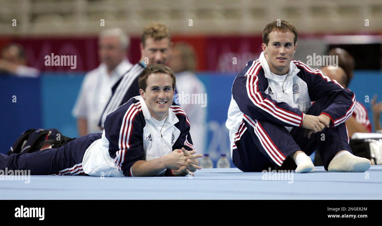 Morgan Hamm, left, of the United States and his brother Paul Hamm watch ...