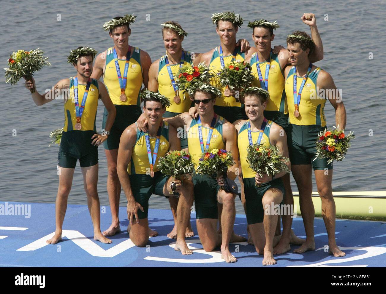 Members of the Australian Men's Eight boat pose on the podium after ...