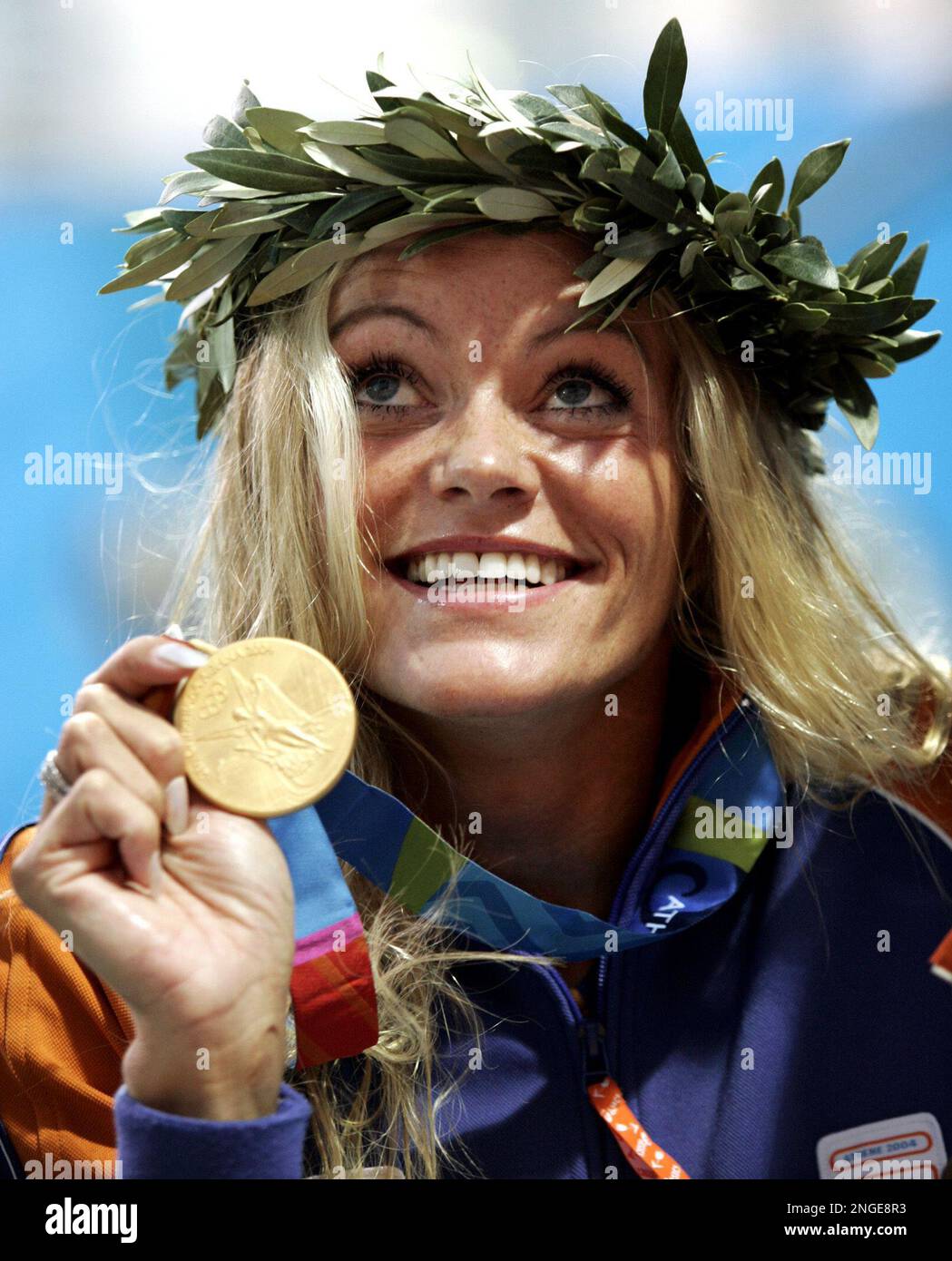 Inge de Bruijn, of The Netherlands, holds her medal after winning the ...