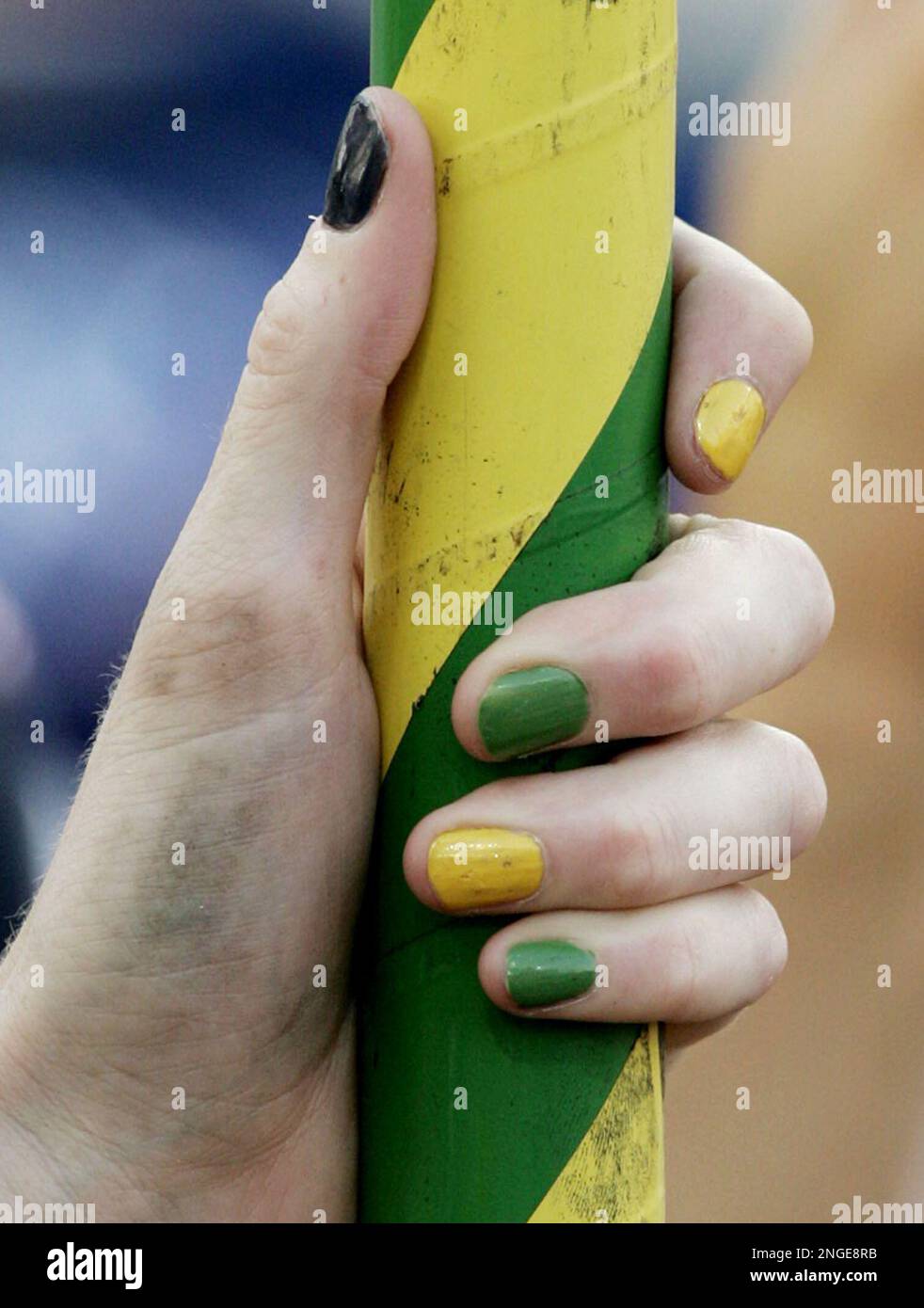 The hand of Australia's Kym Howe, the nails painted in her national colours, holds her pole ...
