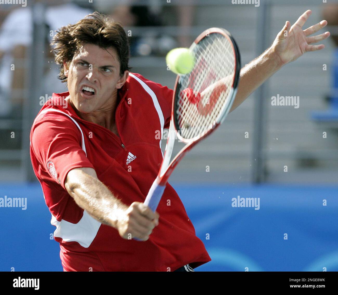 Taylor Dent of the USA returns the ball to Fernando Gonzalez of Chile ...