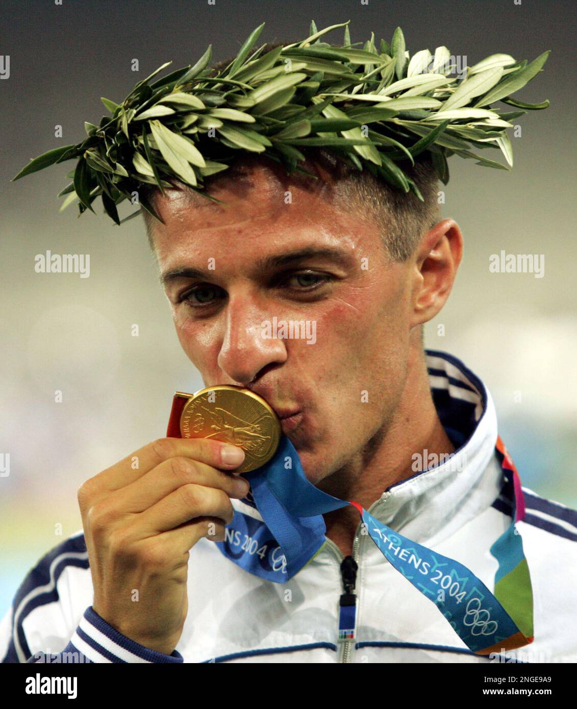 Italy's Ivano Brugnetti kisses his 20 kilometer walk gold medal ...