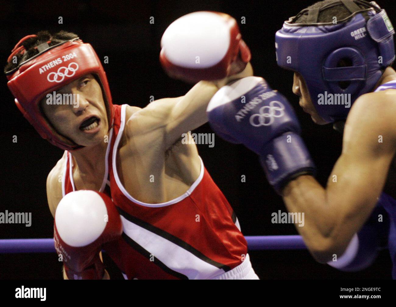 Korea's Baik Jong-sub, left, throws a punch to Mongolia's Munkh Erdene ...