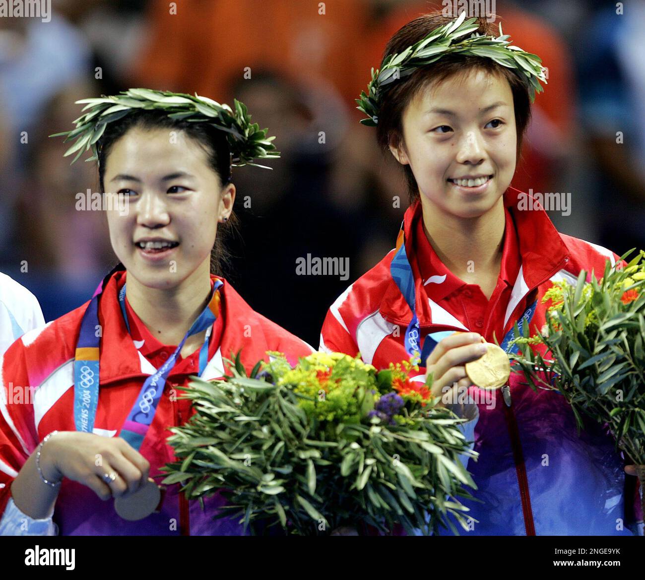 China's Zhang Yining, right, and Wang Nan, receive the gold medal after ...