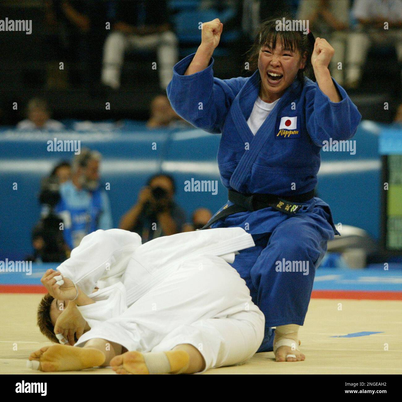 Japan's Anno Noriko, in blue, celebrates after beating Liu Xia, from ...