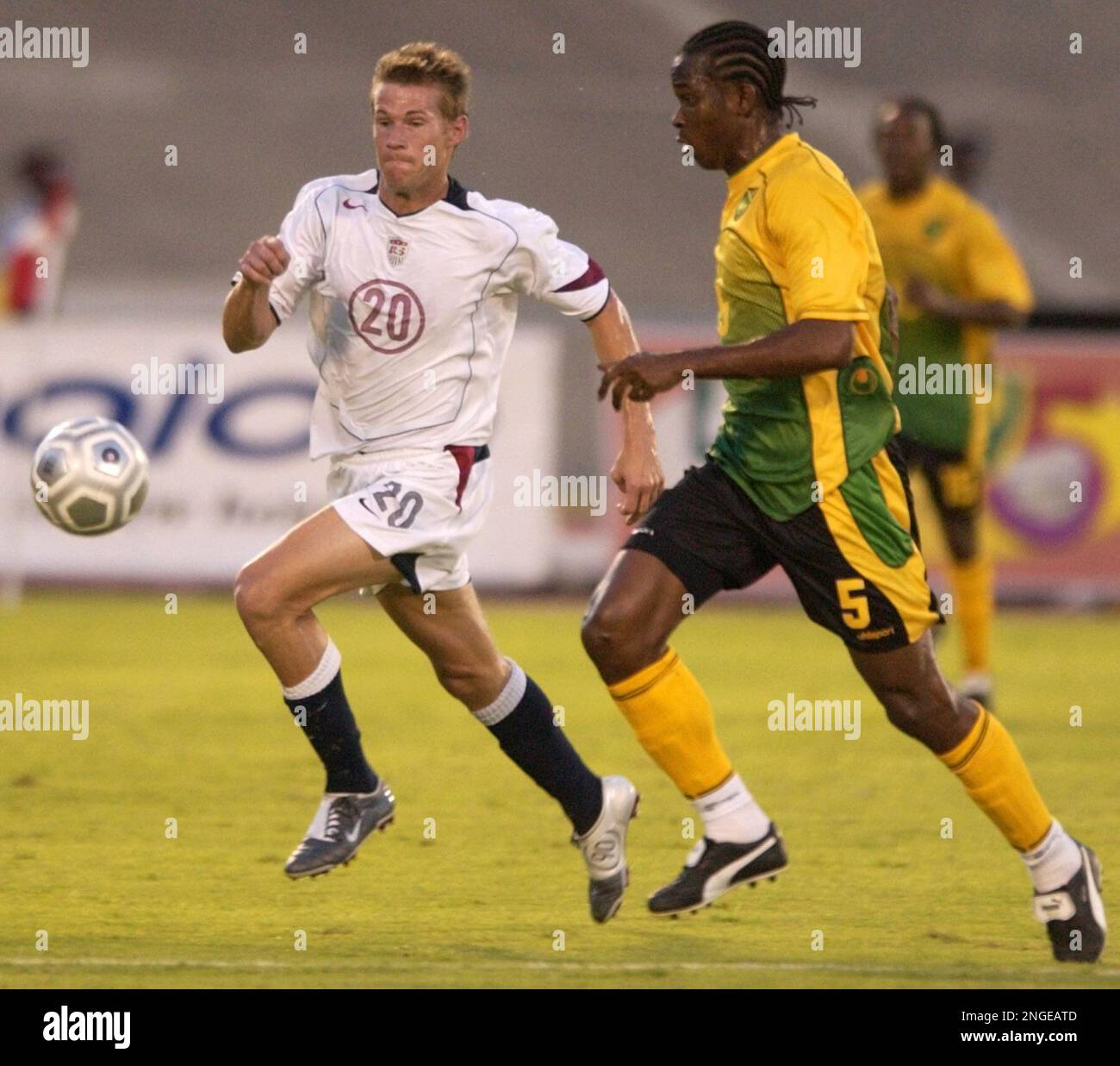 United States' Brian McBride, left, is chased by Jamaica's Ian Goodison ...
