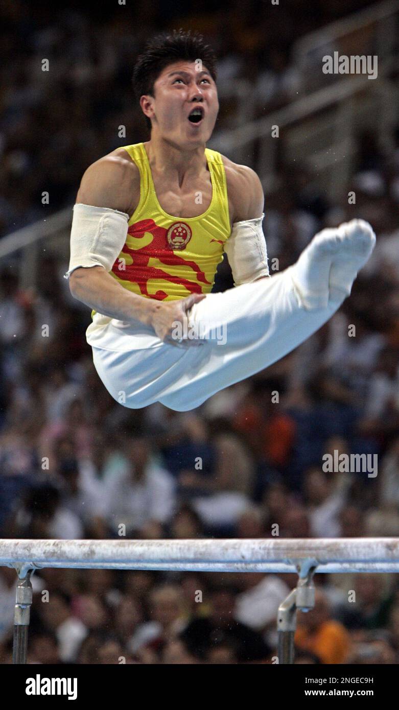 Li Xiaopeng of China competes in the parallel bars during the men's ...