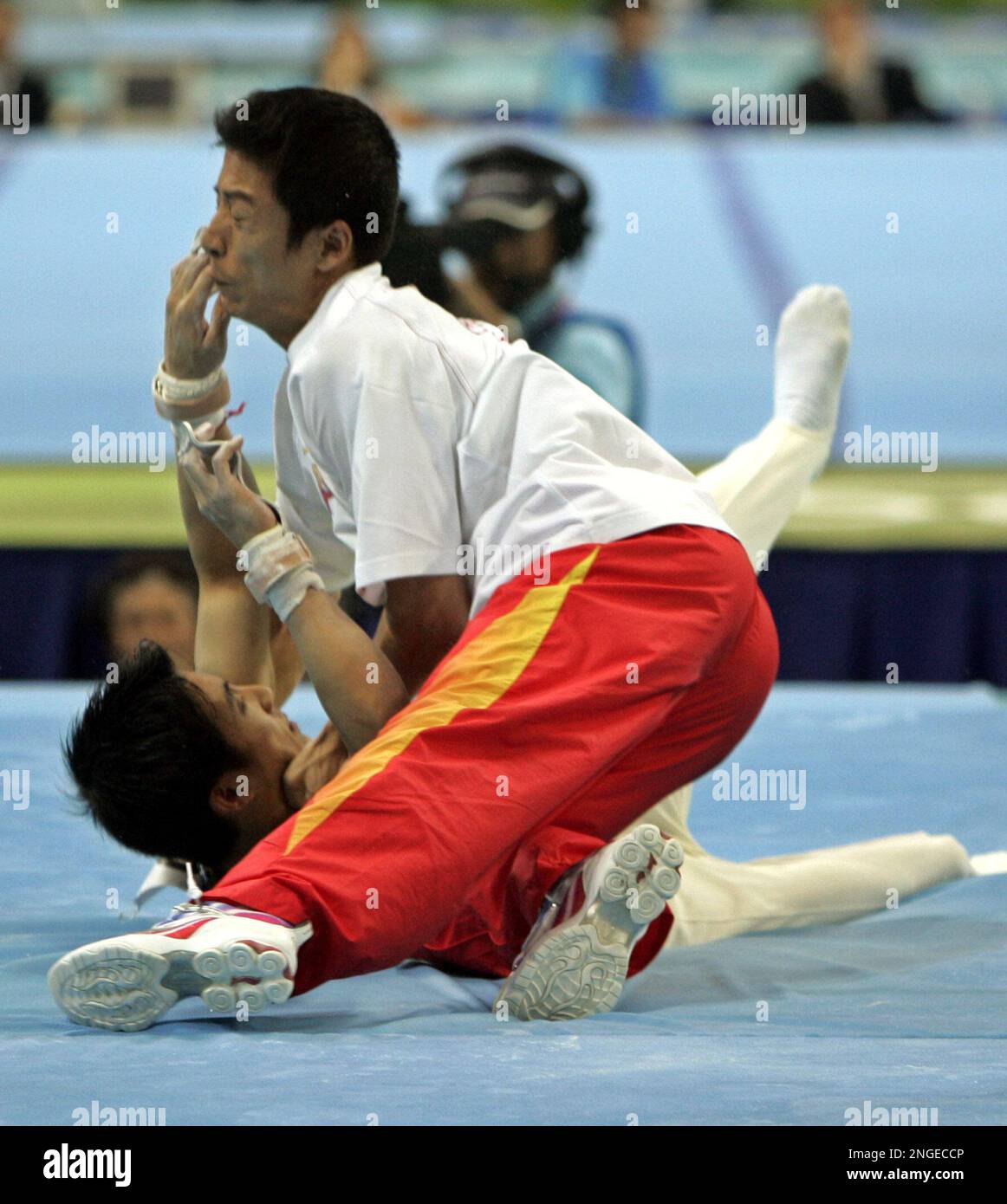 China's Teng Haibin, left, is helped by an unidentified spotter after ...