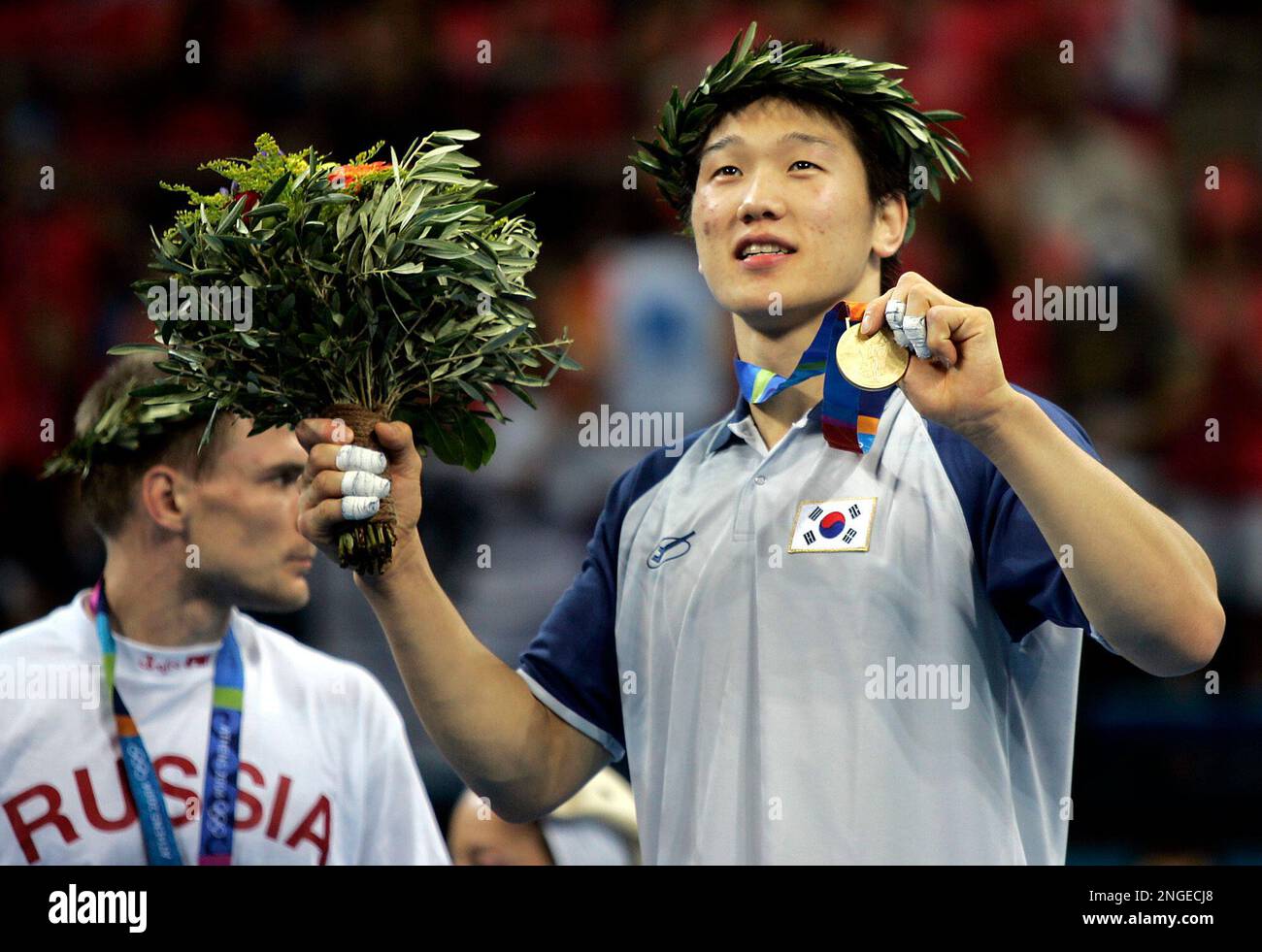Korea's Lee Won Hee is awarded the gold medal in the Men's Lightweight ...