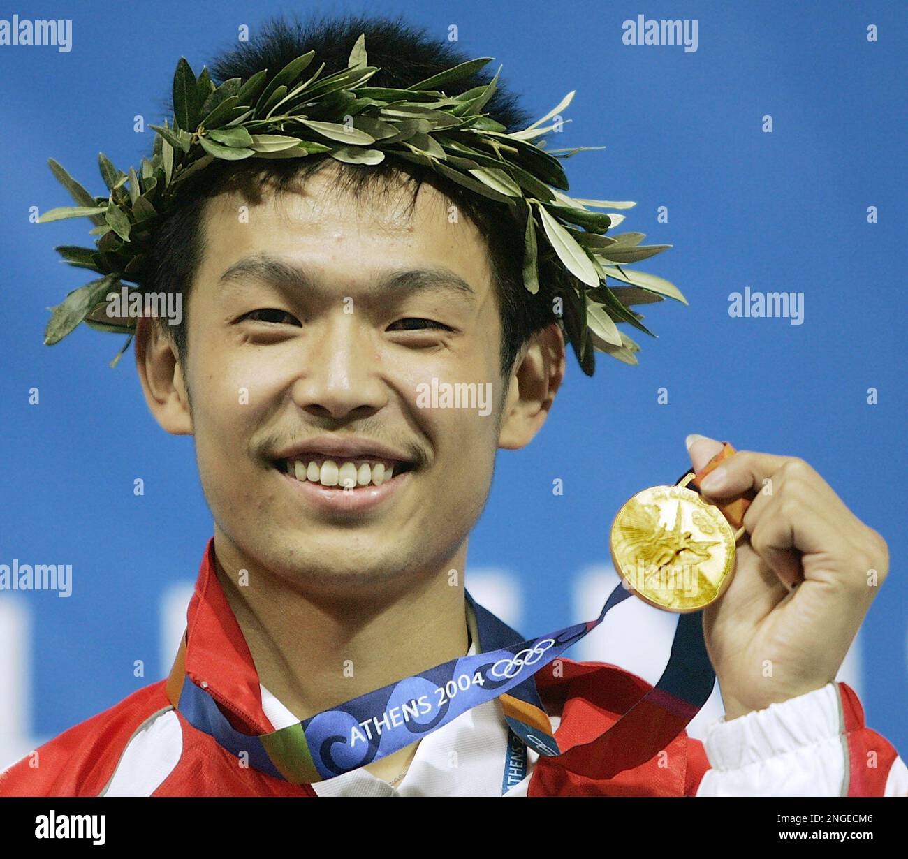 China's Zhu Qinan displays his gold medal after winning the men's 10m ...