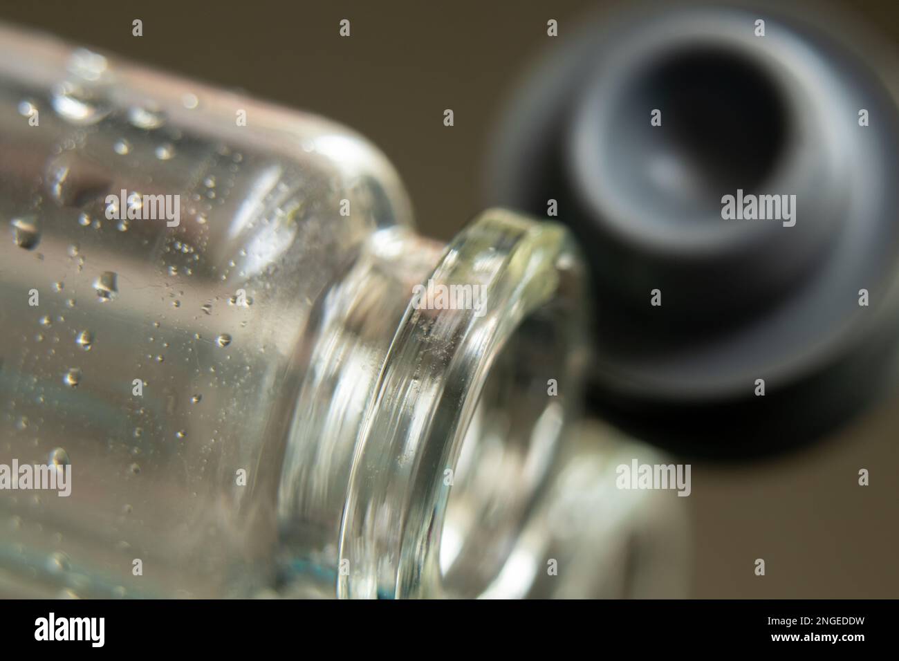 Macrophotograph of a glass drug vial resting on a mirror, test tube ...