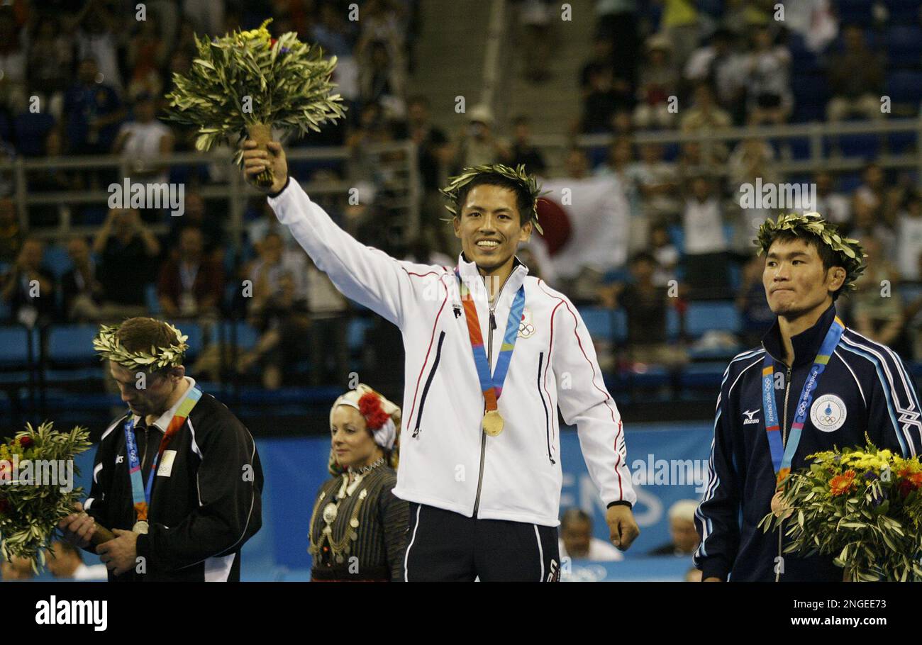 Japan's Tadahiro Nomura, center, celebrates his gold medal in the Men's ...