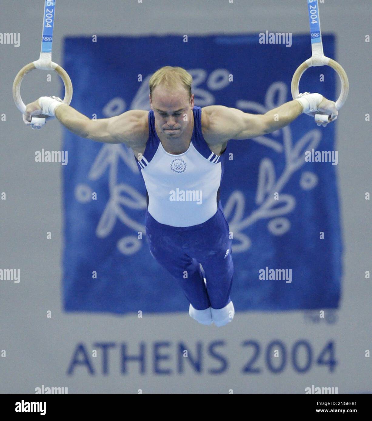 Brett McClure, of the United States, performs his routine on the rings ...
