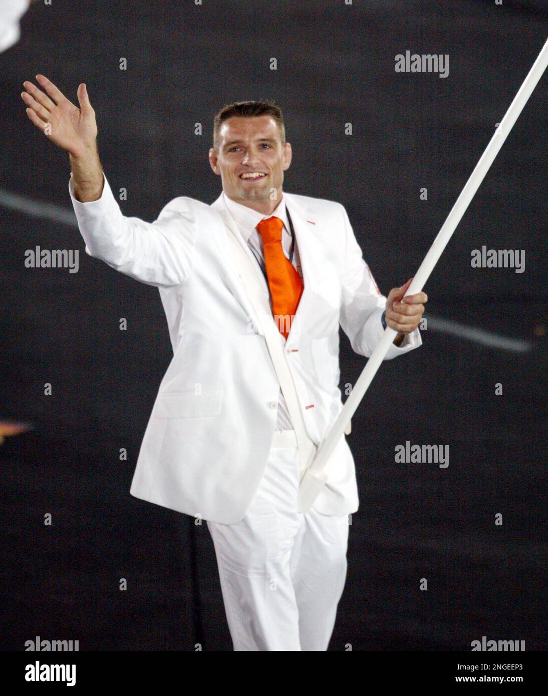 Mark Huizinga carries the flag of the Netherlands during opening ...