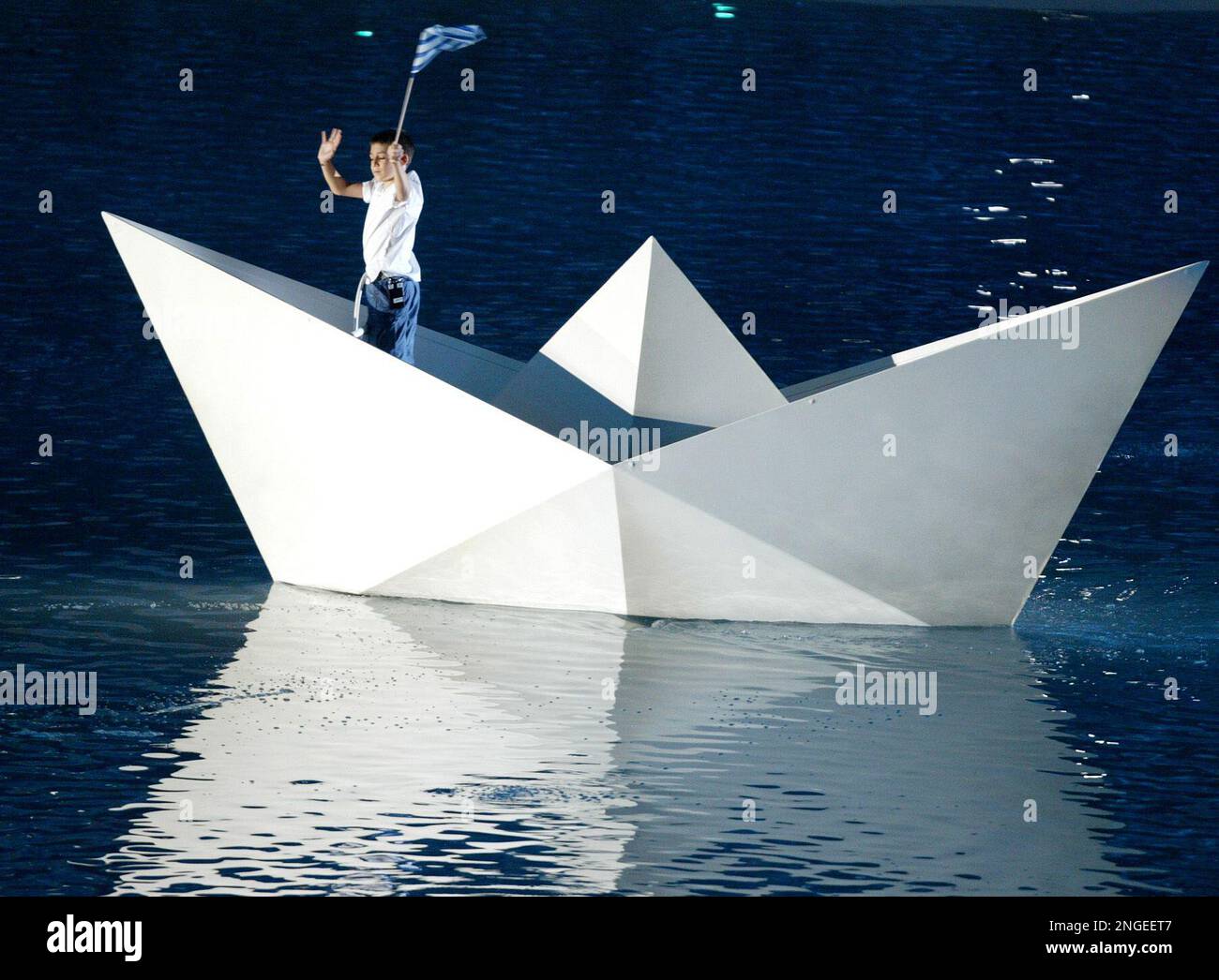 Greek peformer Michalis Patsatzis sails in a boat during the Opening ...