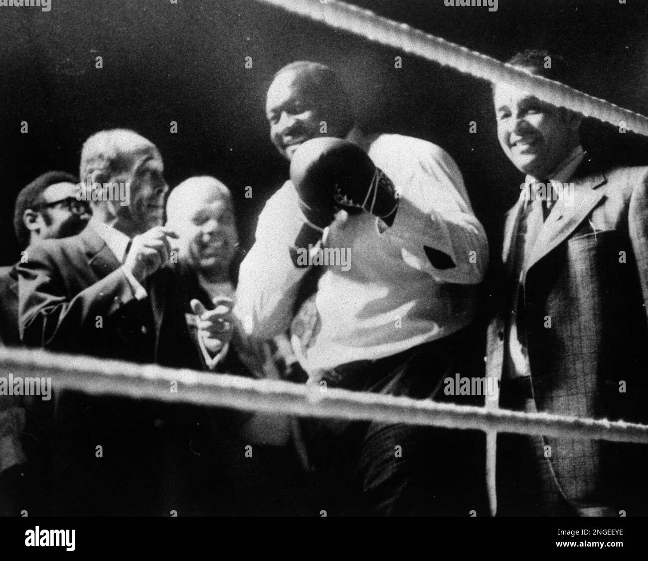 Uganda's President Idi Amin, centre, wearing boxing gloves, squares up ...