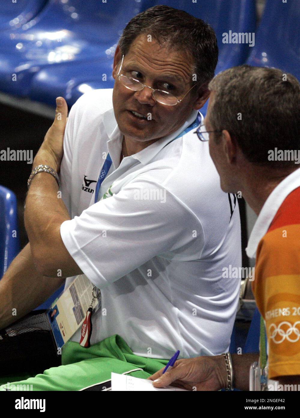 Iraqi boxing coach Maurice Watkins, left, talks to an unidentified ...