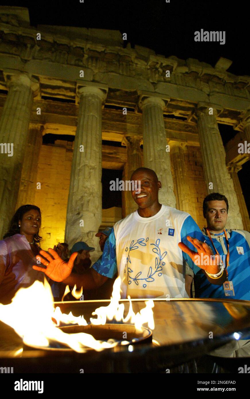 Flanked by a volunteer, right, and his sister Carol, left, Nine times ...