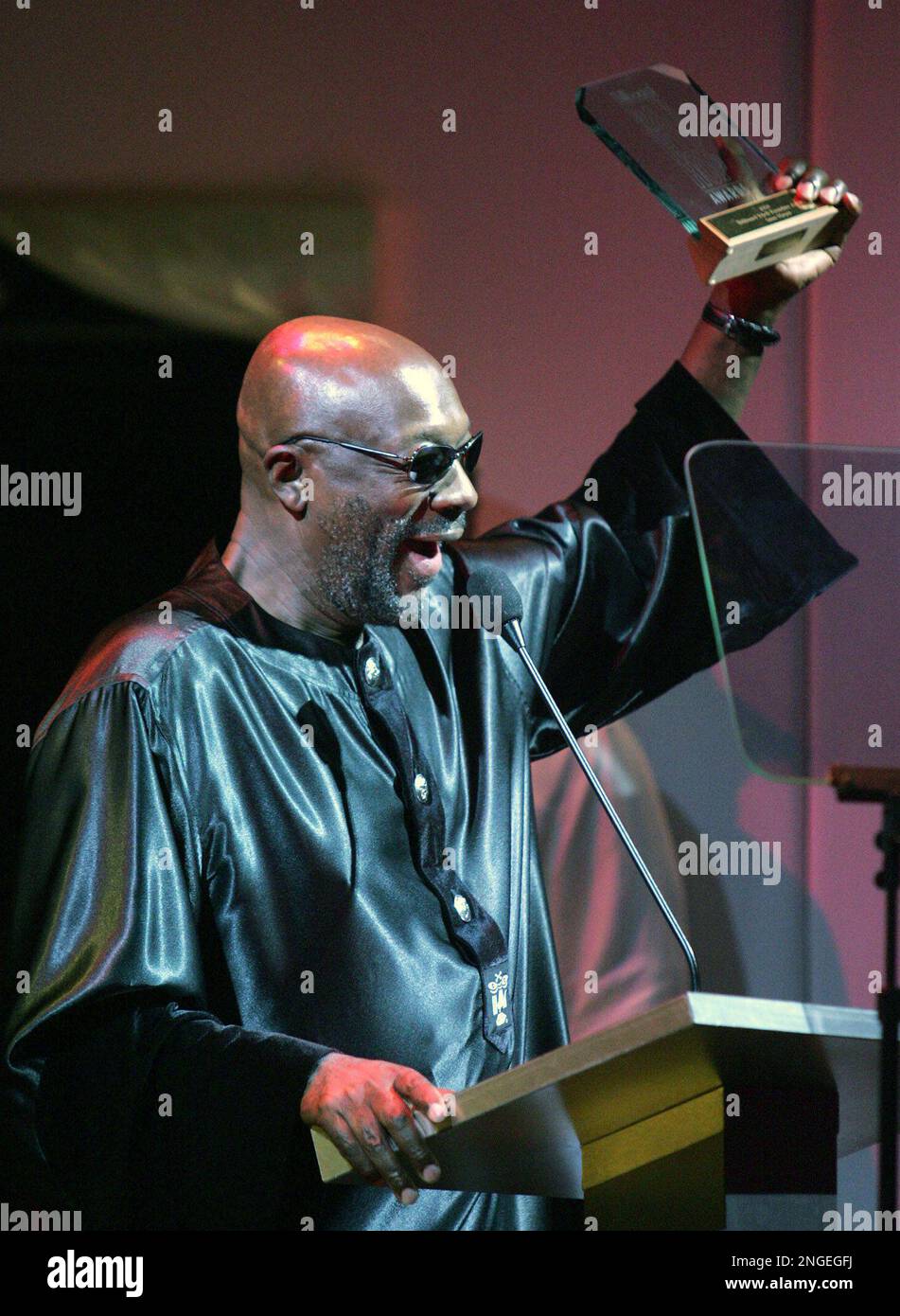 R&B performer and songwriter Isaac Hayes shows his award to the guests ...