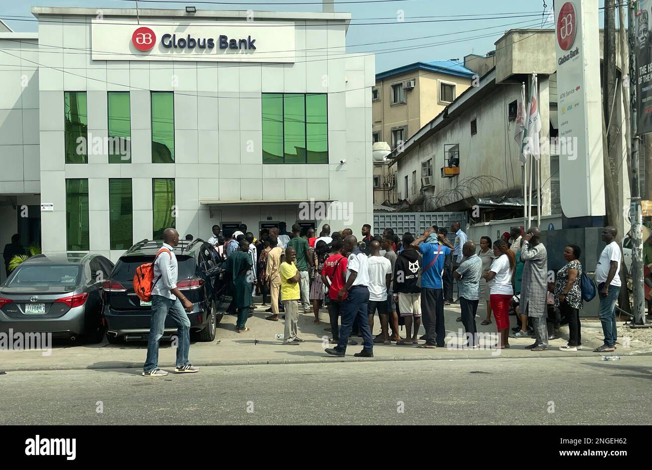 People queue to withdraw money from a cash machine outside a bank in ...
