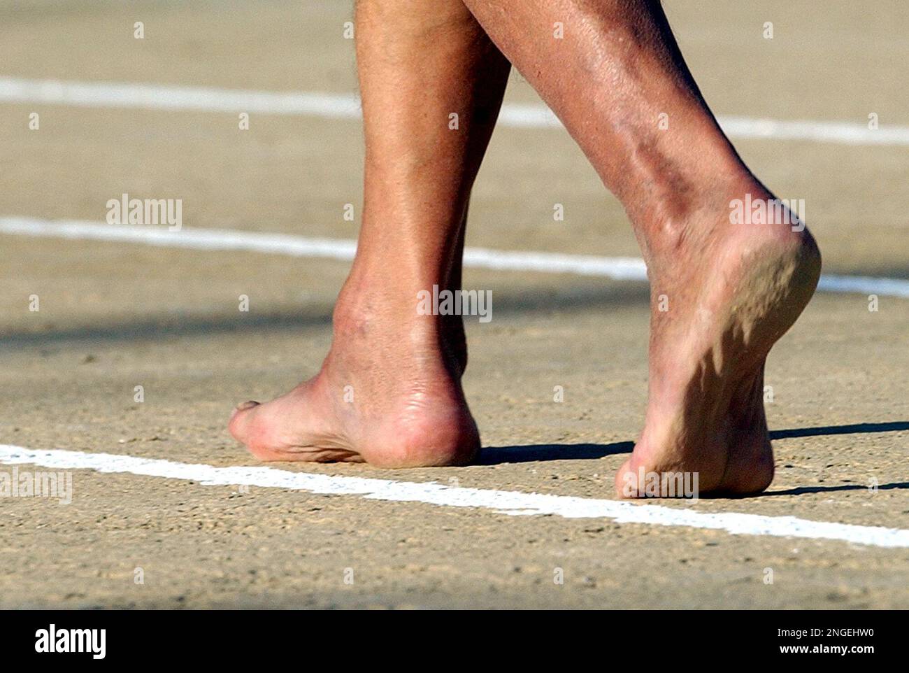 A runner's dusty feet are seen after taking part in a footrace in the ...