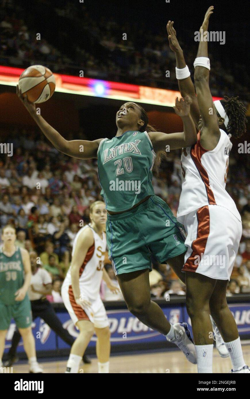 Minnesota Lynx's Tamika Williams, left, drives to the basket around the ...