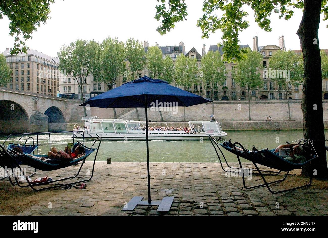 People relax in hammocks at the Paris Beach installation along the ...