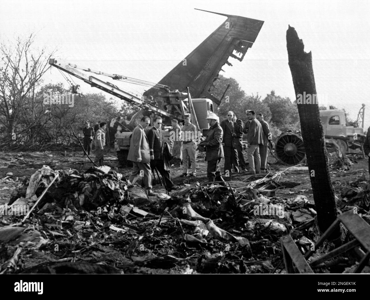 Firemen and civilians survey the scene of devstation around the ...