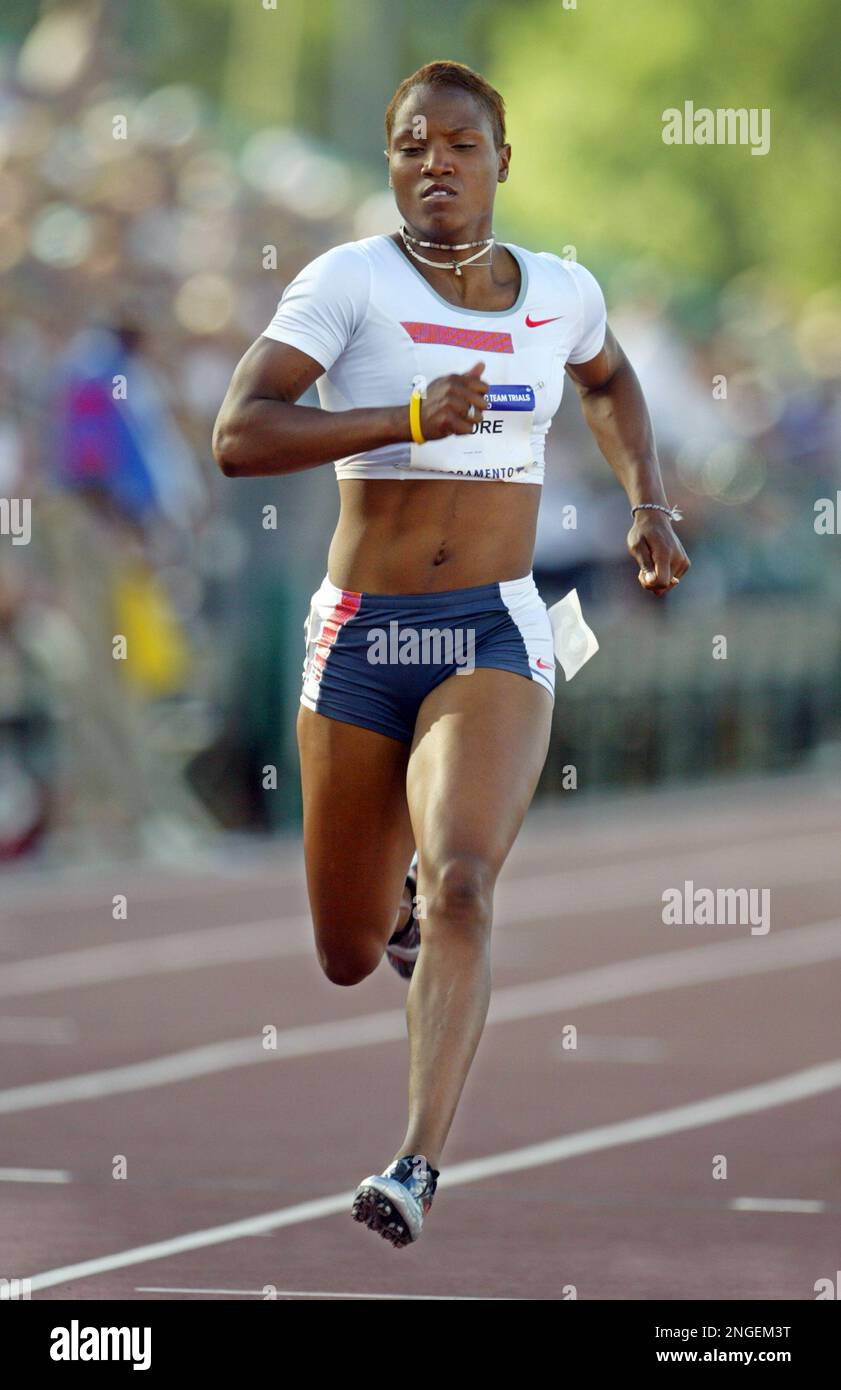 Connie Moore wins her heat in the women's 200 meters during the Olympic ...