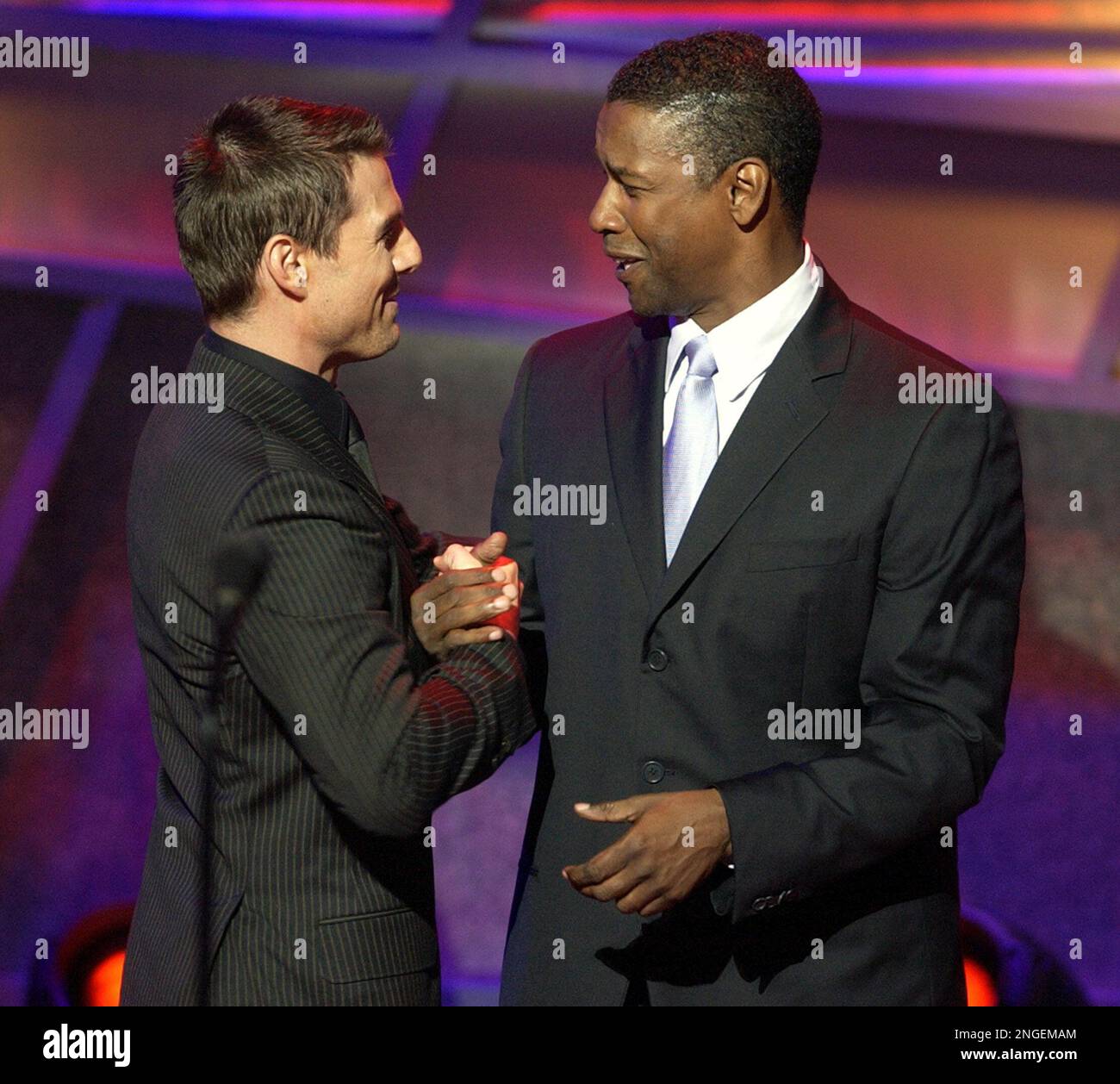 Tom Cruise greets Denzel Washington as they present during the 12th ...