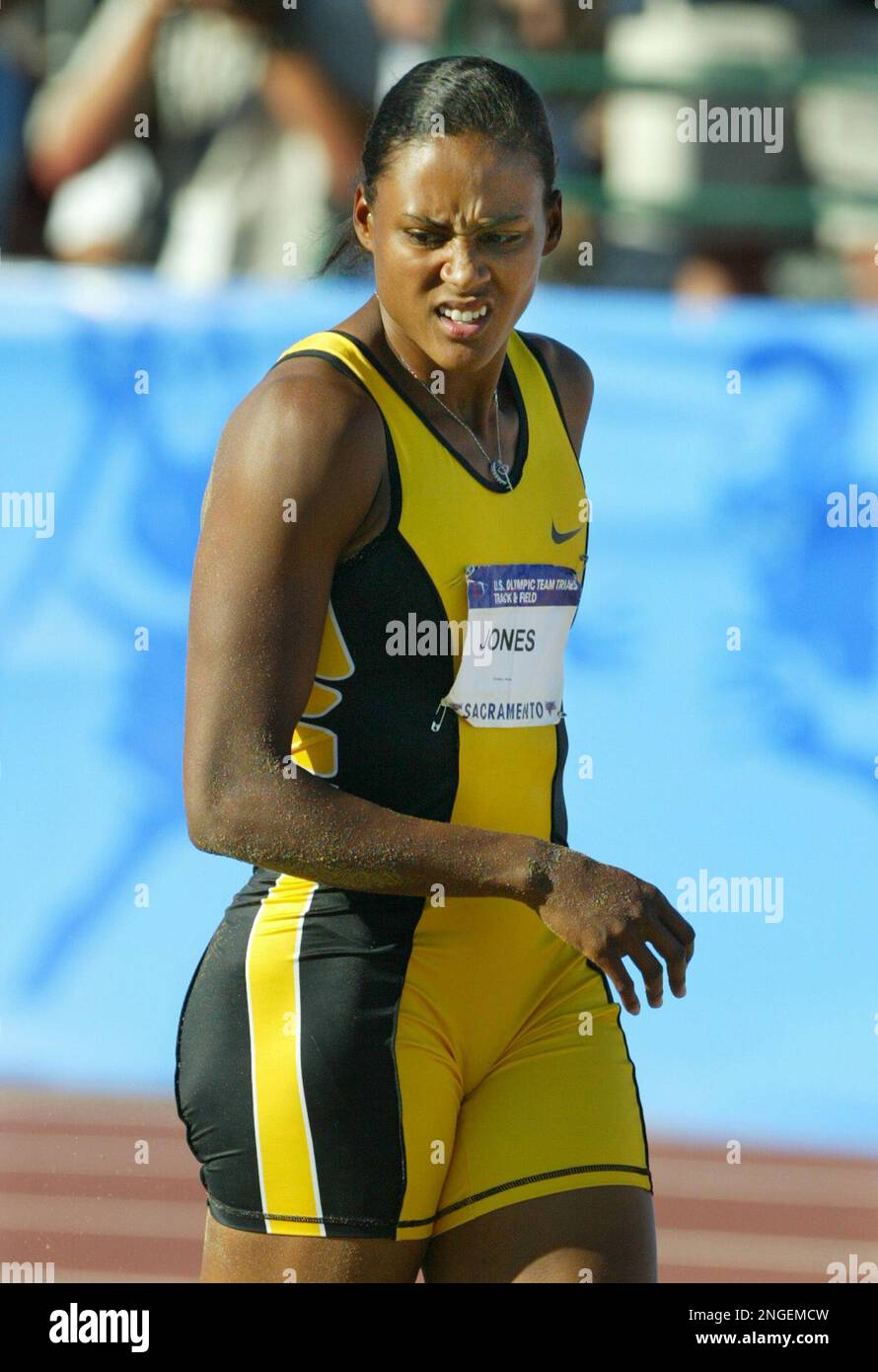Marion Jones looks at her landing spot in the sand following her first ...