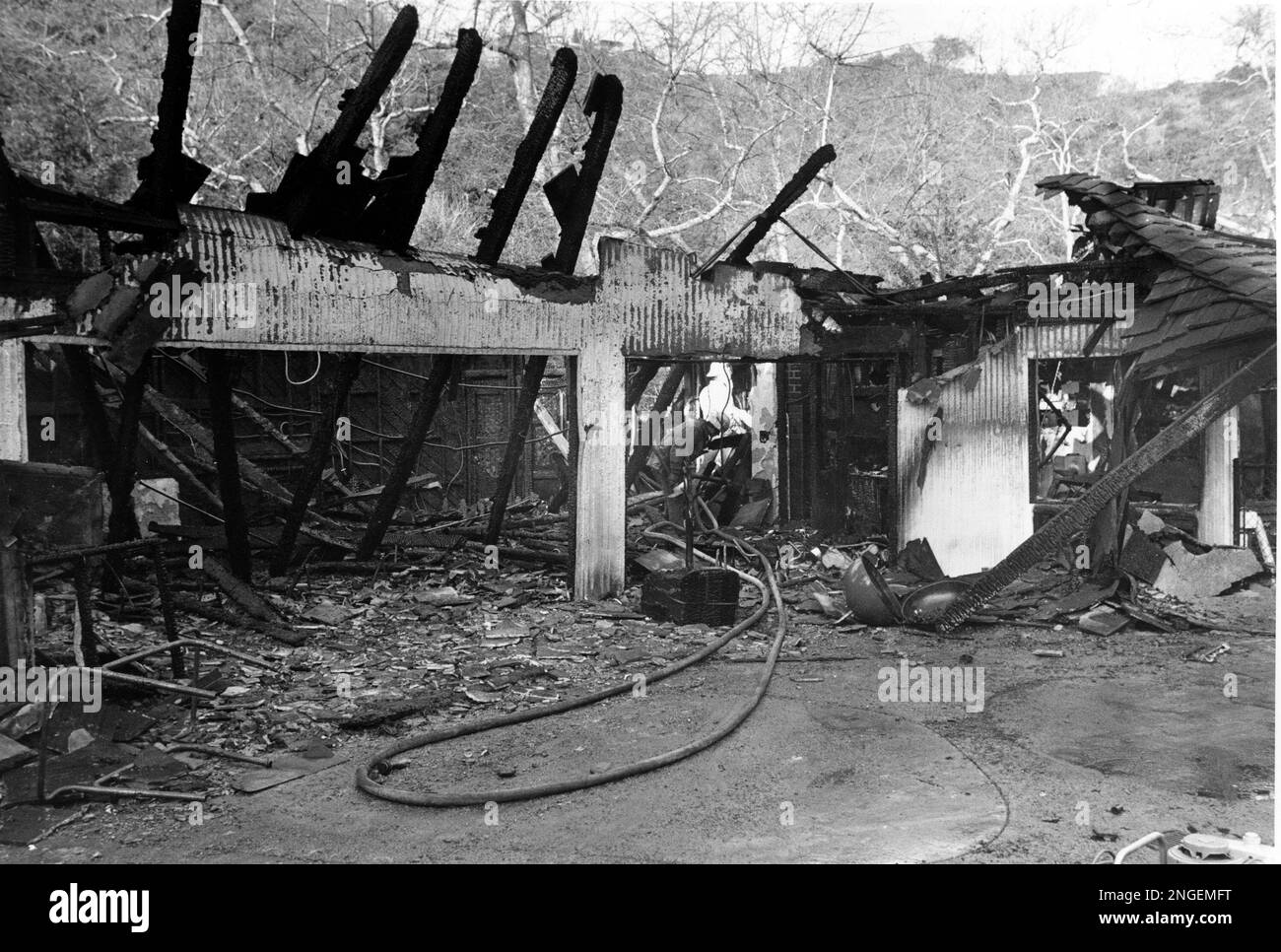 Firemen investigate the aftermath of a fire that destroyed the Bel Air ...