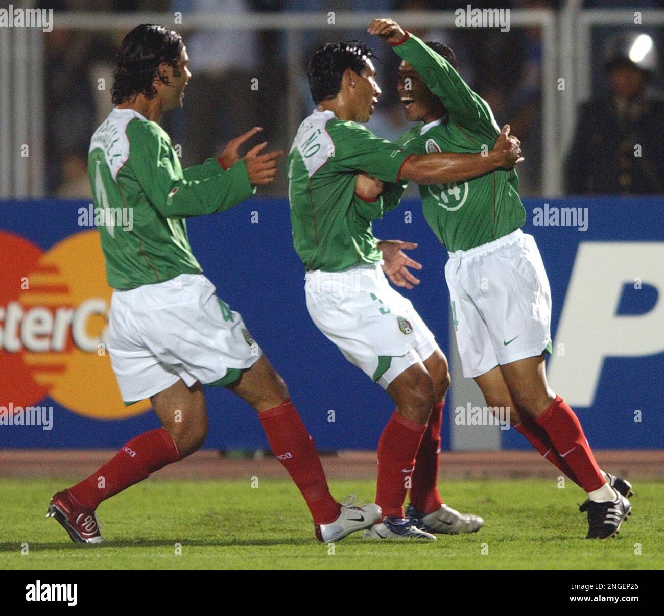Mexico's Ramon Morales, right, is embraced by Omar Briseno, center, and ...