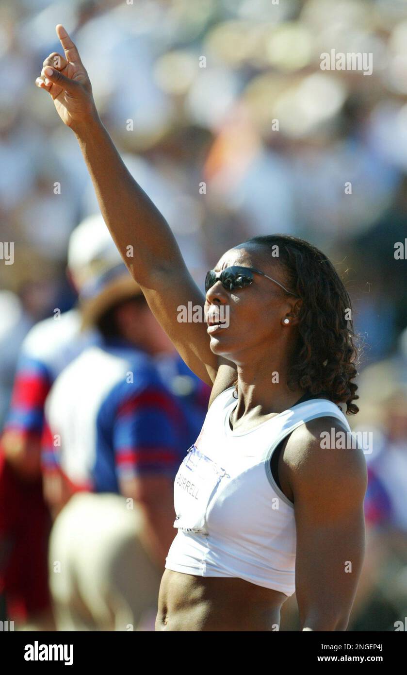 Shelia Burrell gestures to the crowd after competing in the 800 meter ...