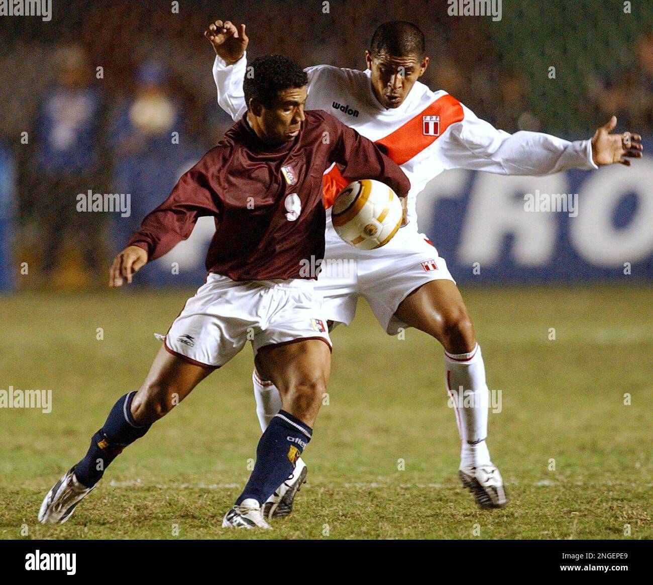 Peru's Santiago Acasiete, right, fights for the ball against Venezuela ...