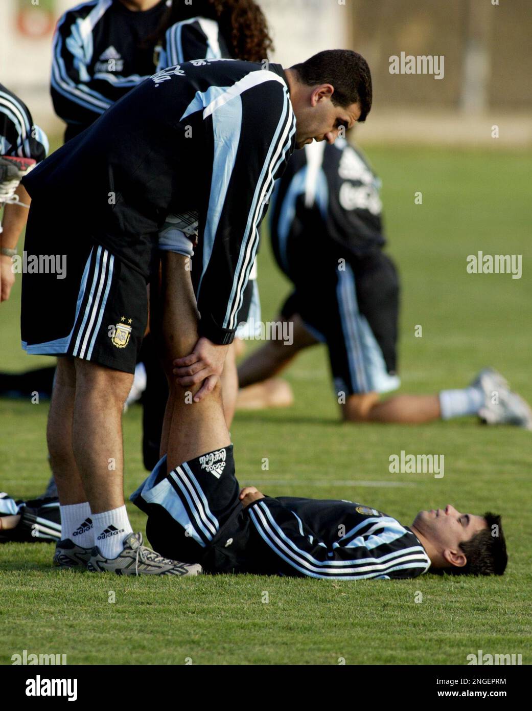 Argentina's Javier Saviola is helped by a trainer during a training ...