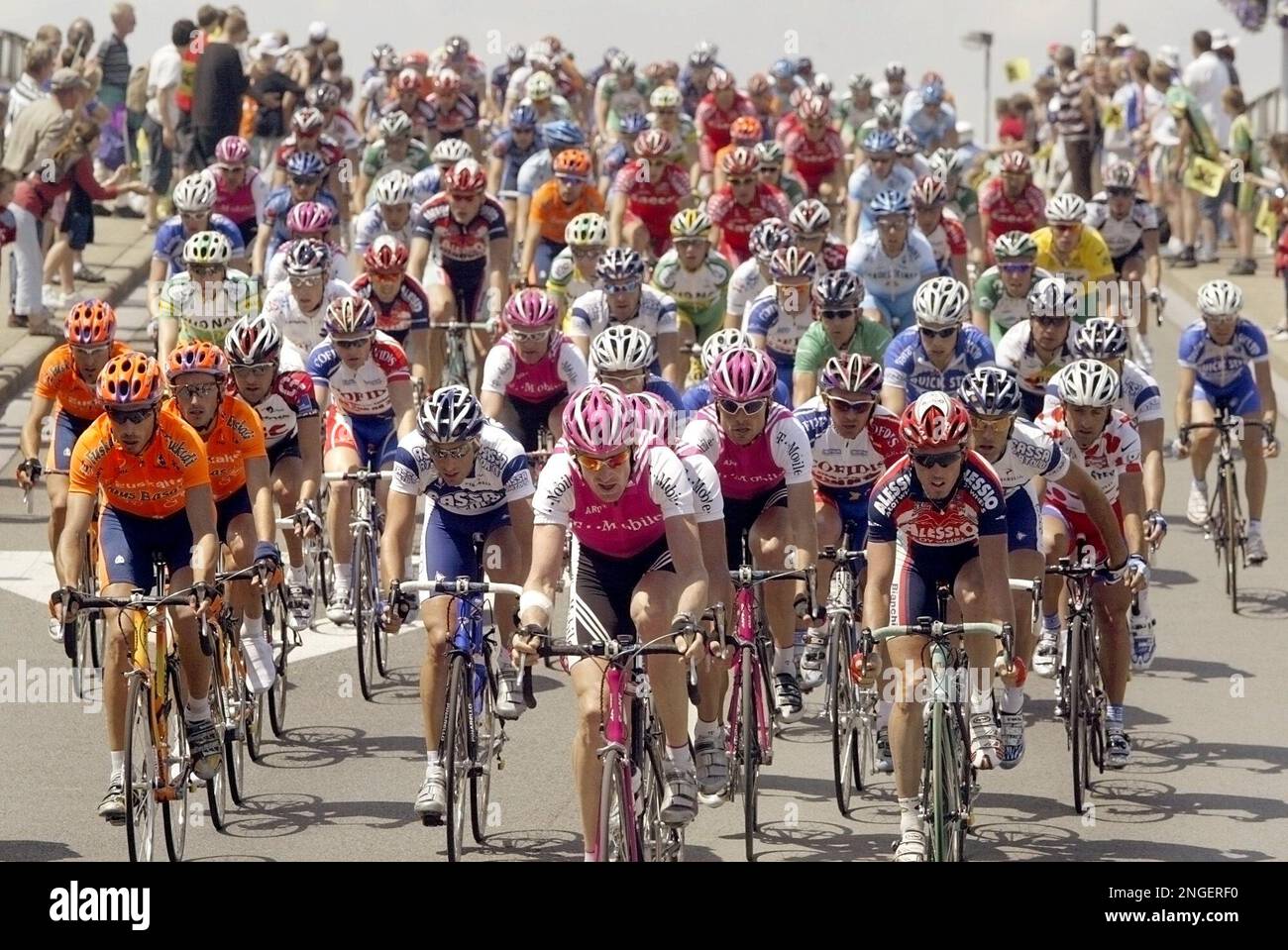 The pack rides over a bridge in Geraardsbergen, Belgium, during the ...