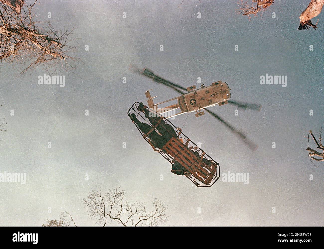 A helicopter lifts a wounded American soldier on a stretcher during ...