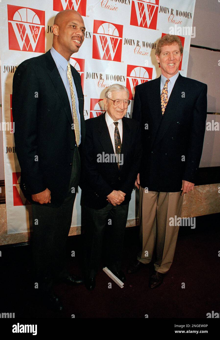 Former UCLA coach John Wooden, center, stands with two of his former ...