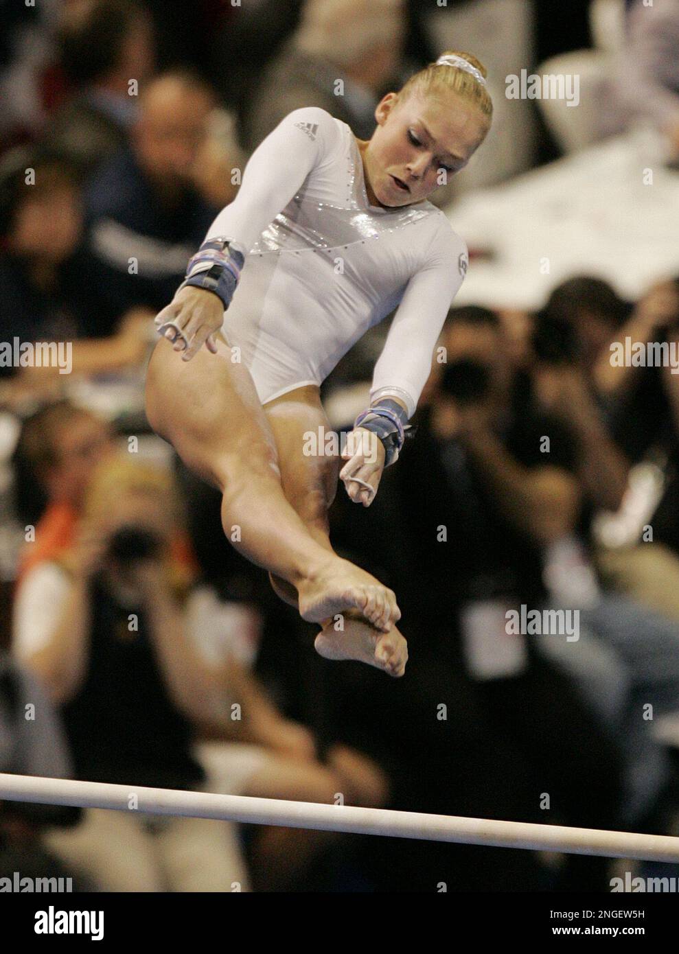 Courtney McCool performs on the uneven bars in the final round of the ...