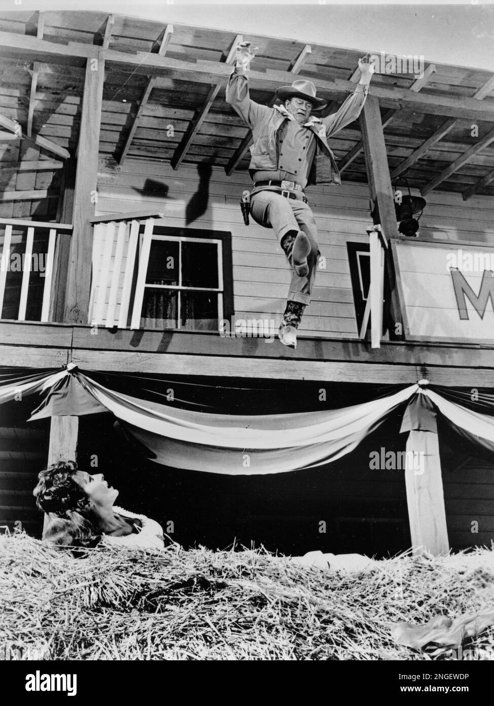 Actor John Wayne does his own stunt jump in a scene with co-star Maureen O'Hara, left, in the ...