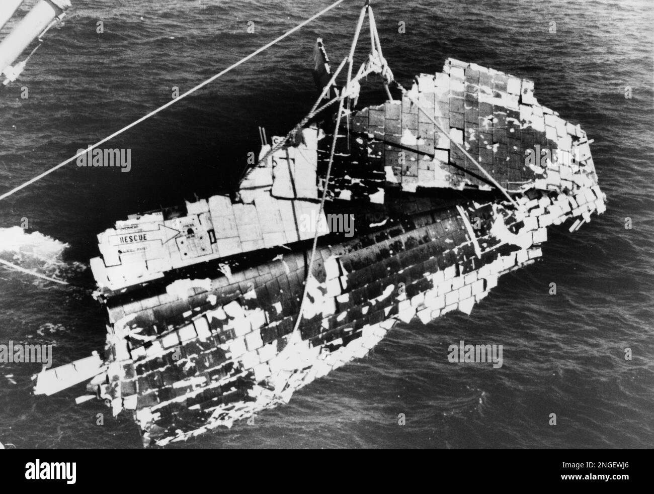 Coast Guardsmen hoist the right front section of the space shuttle ...