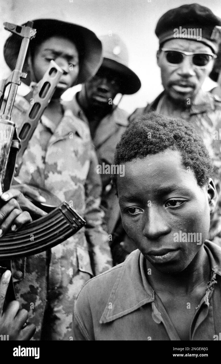 A soldier of the FNLA is surrounded for questioning by his captors ...