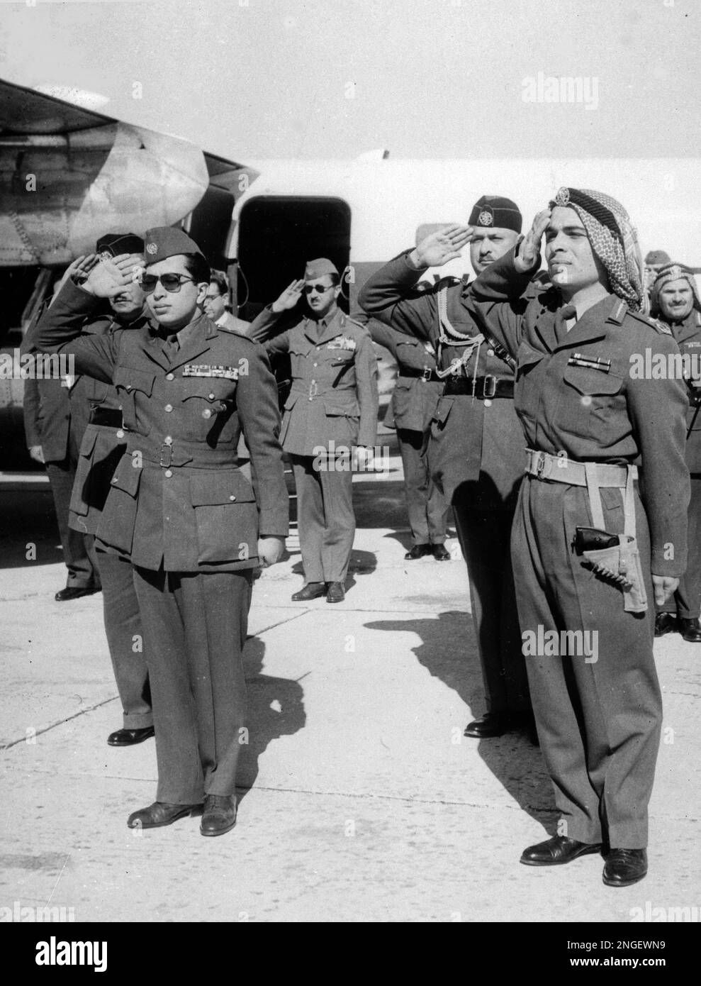 King Faisal II of Iraq, left, salutes a review of the Arab Legion ...