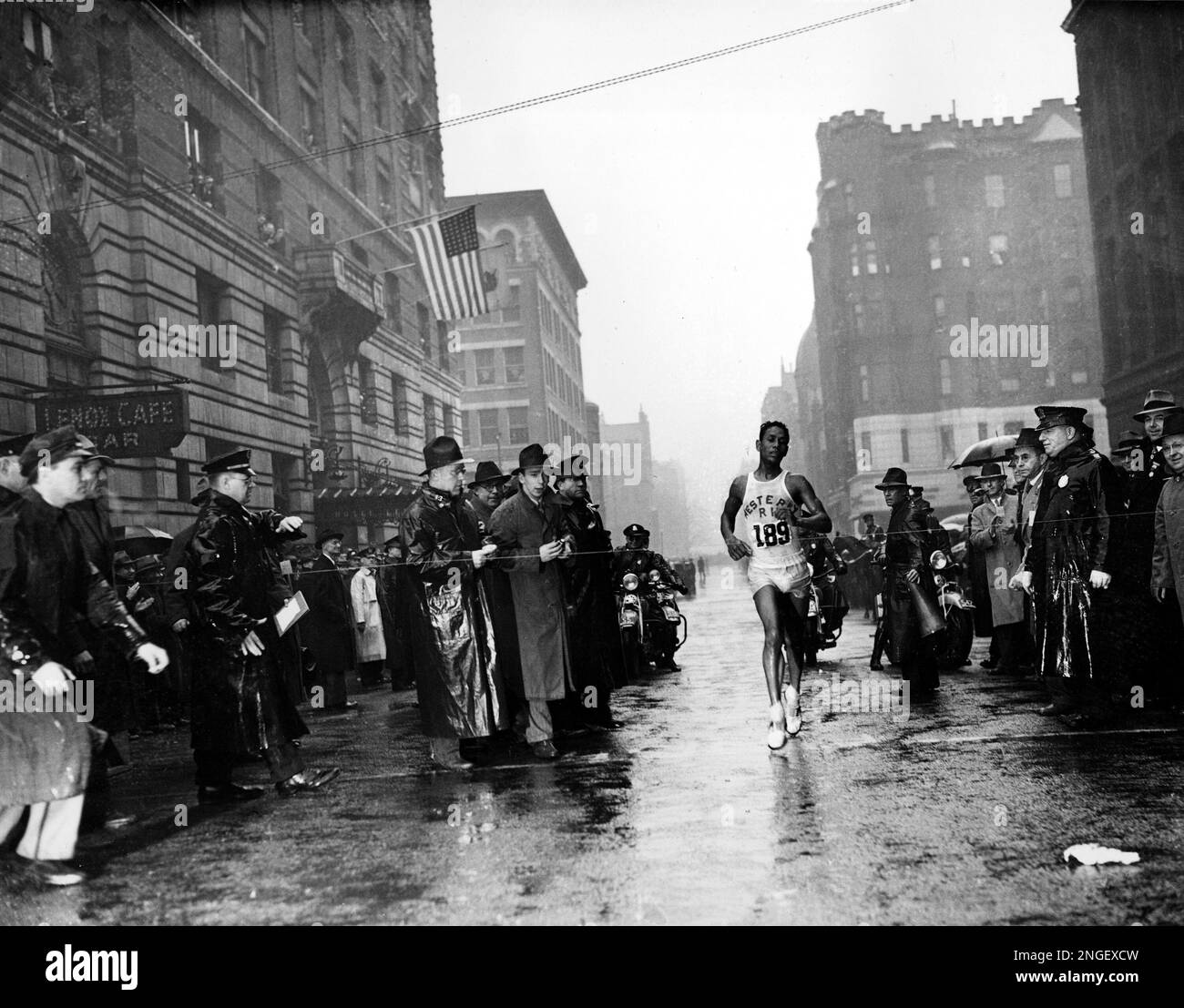 Ellison M. "Tarzan" Brown, from Alton, R.I., crosses the finish line in ...